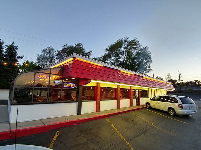 As dusk settles, Olympus Burgers glows with promise. The red-roofed sanctuary where pastrami pilgrims find their beefy bliss.