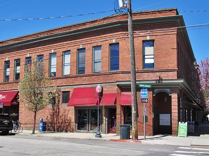 This beautiful corner building showcases Sandpoint's preserved architecture, with cheerful red awnings inviting visitors to explore local shops and eateries.