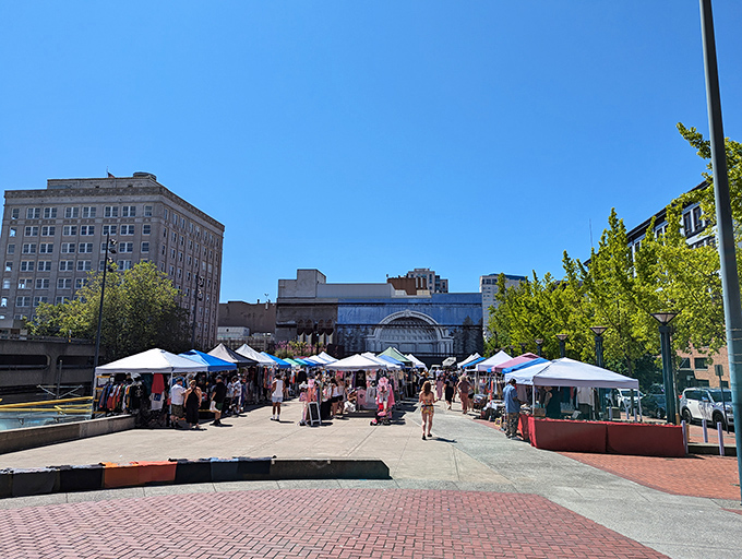Bright blue skies frame Tacoma's market day, where shoppers stroll between white tents in search of that perfect something.