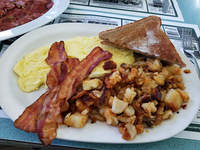 The breakfast trinity &ndash; perfectly cooked eggs, crispy bacon, and home fries that somehow manage to be both crispy and tender. Morning salvation on a plate.