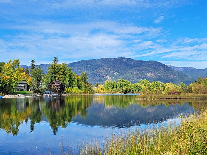 Fall foliage creates a painter's palette around the calm waters near Sandpoint. Even the clouds can't resist checking their reflection in this perfect mirror.