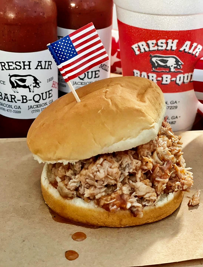 The sandwich that launched a thousand road trips &ndash; chopped pork piled high on a soft bun with a tiny American flag saluting your good taste.