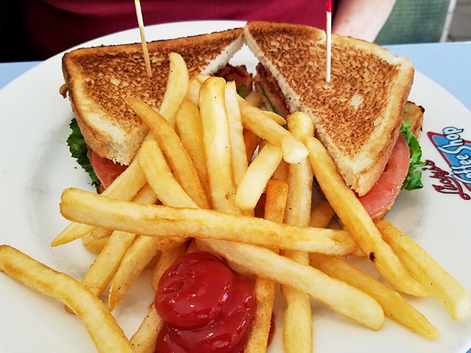 Golden-brown toast embracing fresh ingredients with a pickle sentinel standing guard&mdash;comfort between bread slices.