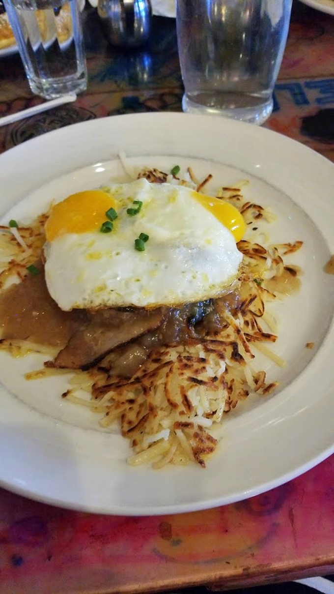 Eggs sunny-side up crowning a throne of hash browns and meat. Like breakfast royalty that doesn't need a fancy castle to rule your taste buds.