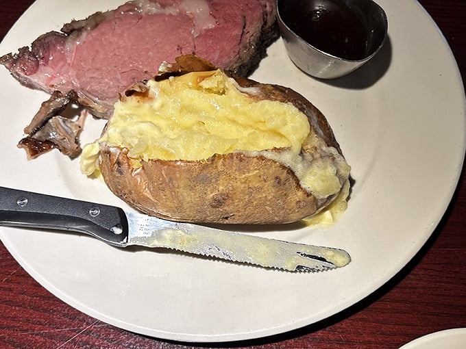 That loaded baked potato isn't just a side dish &ndash; it's practically auditioning to be the main event with its mountain of melted cheese.