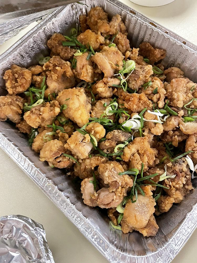 Crispy, golden chicken bites garnished with green onions. Proof that sometimes the best things in life come in aluminum containers.