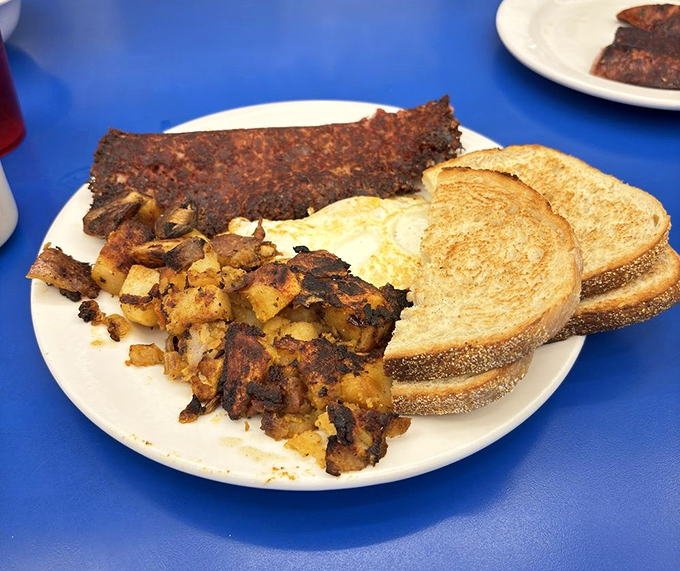 The breakfast that launched a thousand ships&mdash;home fries charred to perfection alongside eggs and what appears to be linguica.