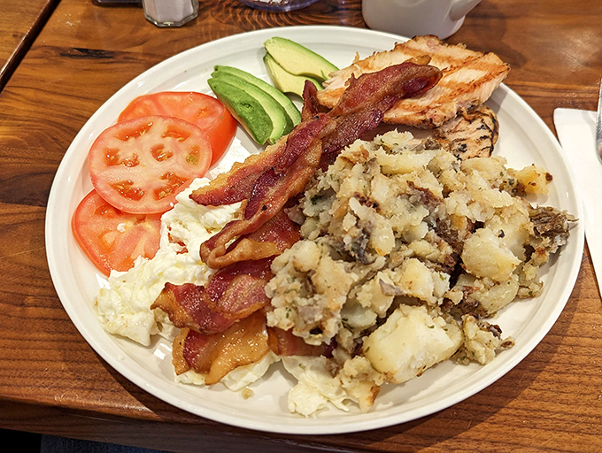 Home fries that actually taste like home, bacon cooked to perfection, and fresh vegetables that didn't come from a freezer. This plate is breakfast democracy in action.