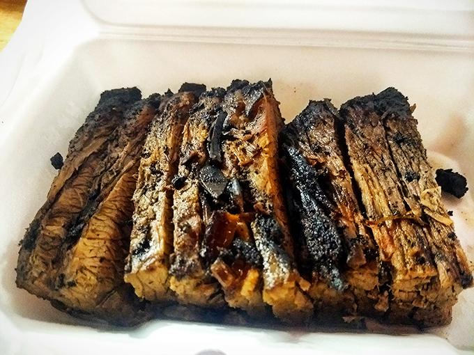 Brisket sliced thick with that telltale smoke ring&mdash;the BBQ equivalent of a gold medal. Each piece tells the story of patience and wood-fired perfection.