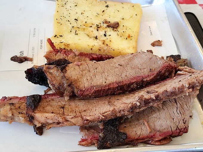That smoke ring and perfect bark tell you everything: this brisket has been loved for hours.