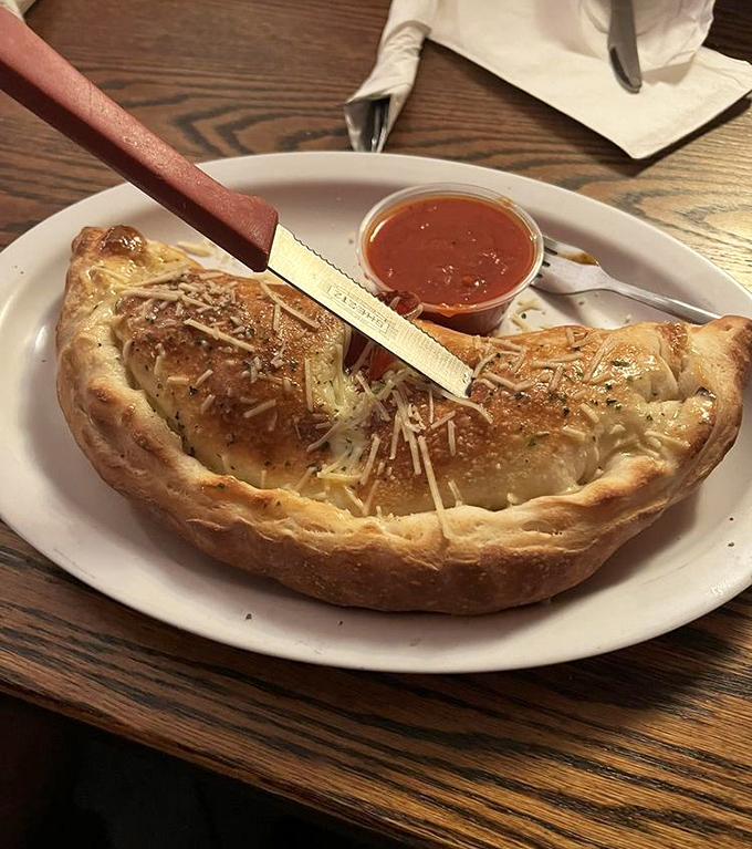 This calzone isn't just folded pizza&mdash;it's a golden-brown treasure chest filled with molten cheese riches.