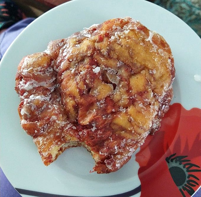 The cherry fritter looks like it got into a fight with a powdered sugar shaker and gloriously lost. Each bite reveals pockets of fruity treasure.