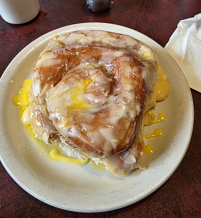 The cinnamon roll arrives looking like it's auditioning for a starring role in your breakfast dreams&mdash;glistening, enormous, and utterly irresistible.