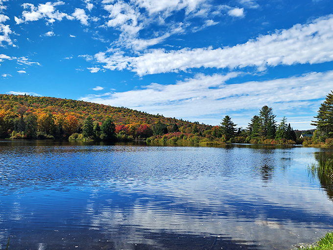 Coffin Pond reflects the surrounding mountains like nature's own Instagram filter, no smartphone required for this kind of serenity.