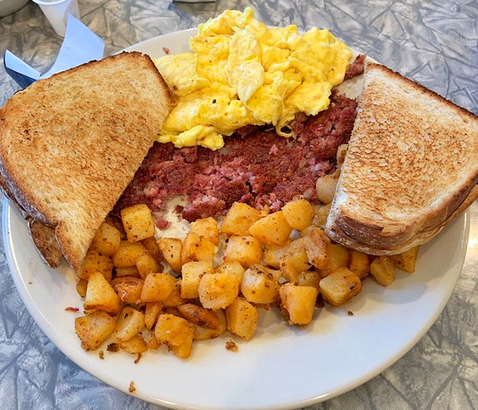The holy trinity of breakfast perfection: crispy home fries, scrambled eggs, and corned beef hash that puts canned versions to shame. This is what breakfast dreams are made of.