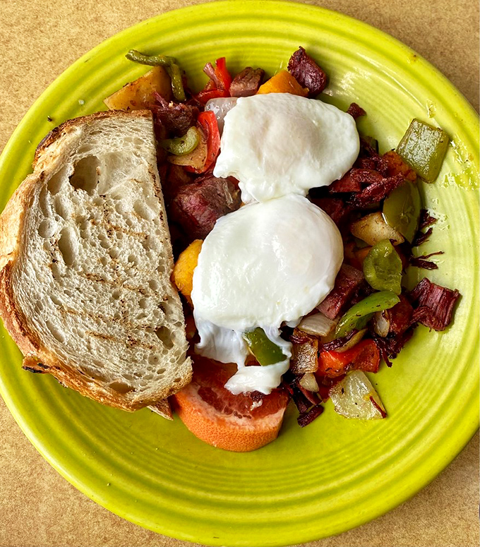 Two poached eggs crown a colorful hash that's like a farmers market threw a party on your plate. The toast is just there to soak up the glory.