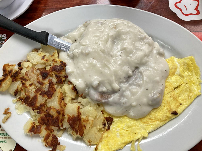 Country fried steak and gravy alongside golden hash browns—proof that some breakfast combinations are simply ordained by the breakfast gods.