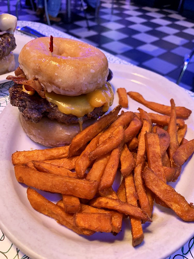 Behold the donut burger—where breakfast and lunch stopped fighting and fell madly in love. Those hand-cut fries are the wedding guests celebrating the union.