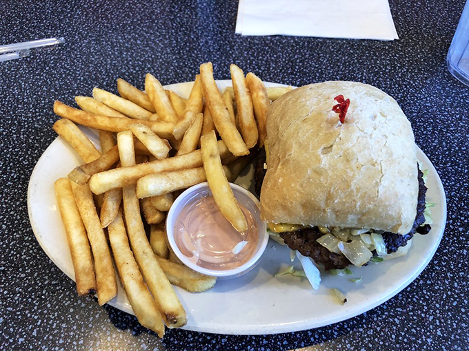 The burger-and-fries combo arrives like old friends reuniting on your plate, comfort food at its finest.