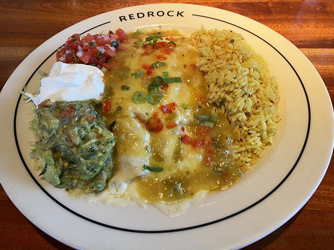 Redrock's enchilada plate arrives like a colorful fiesta, complete with rice, guacamole, and enough cheese to make Wisconsin jealous.