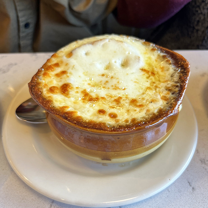 French onion soup with that glorious cheese cap&mdash;the kind of bubbling, golden masterpiece that makes you temporarily forget your table manners.