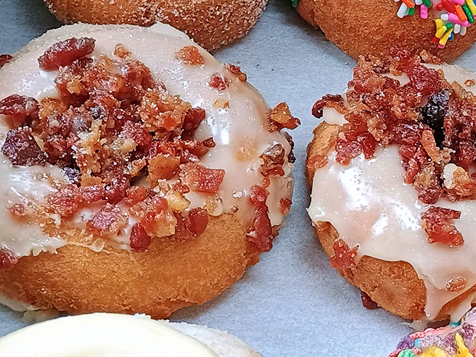 The Dizzy Pig donut combines maple glaze with crispy bacon bits, proving that breakfast's greatest hits album fits perfectly on a donut.