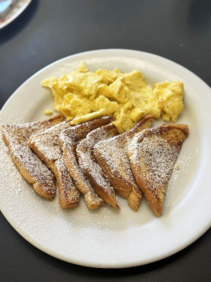 French toast dusted with powdered sugar alongside scrambled eggs&mdash;breakfast's perfect marriage. Simple, unpretentious, and exactly what your morning needs.