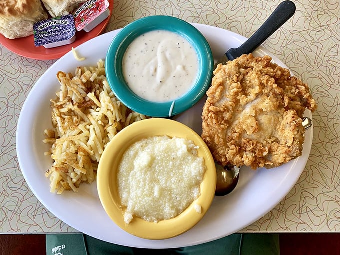 Southern comfort on a plate: creamy grits, country-fried goodness, and gravy that could make a vegetarian question their life choices.
