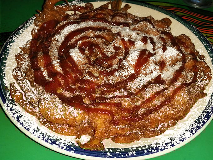 This funnel cake spiral isn't just dessert&mdash;it's edible performance art, dusted with powdered sugar and drizzled with what can only be described as happiness.