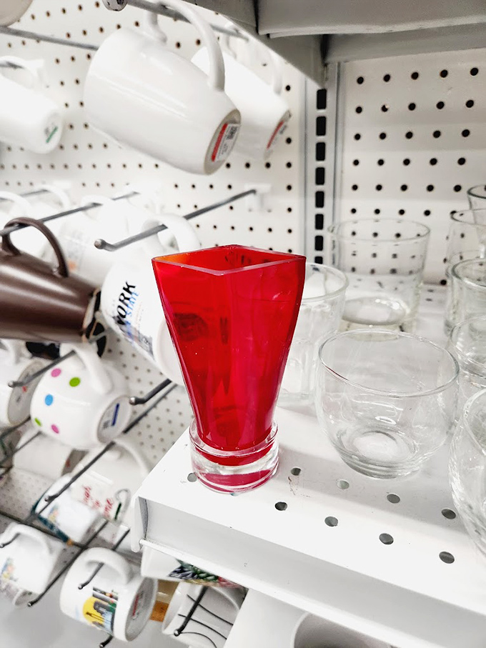 That pop of red glass might be exactly what your living room needs. One person's decluttered shelf becomes another's statement piece.