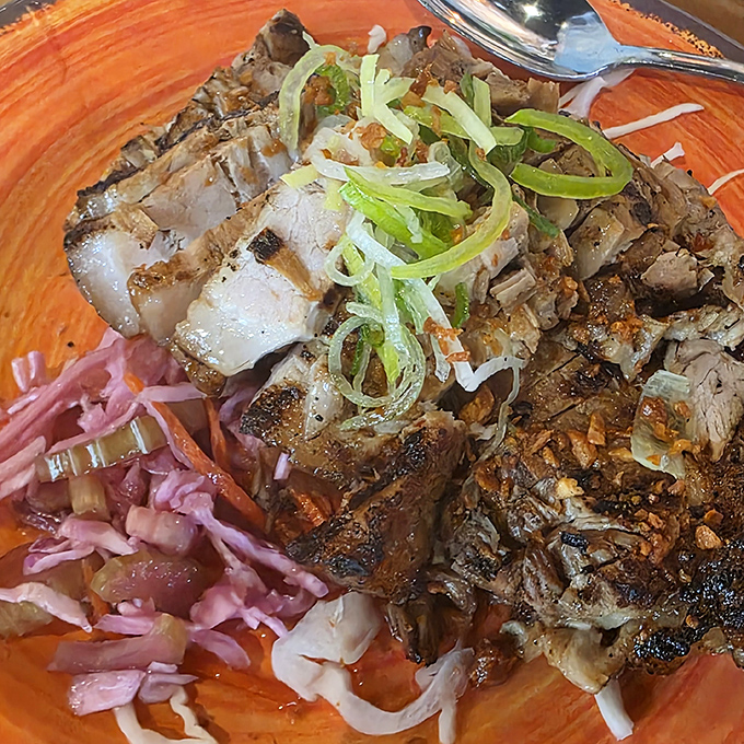 Grilled pork belly adorned with fresh scallions &ndash; proof that sometimes the simplest preparations yield the most spectacular flavor bombs.