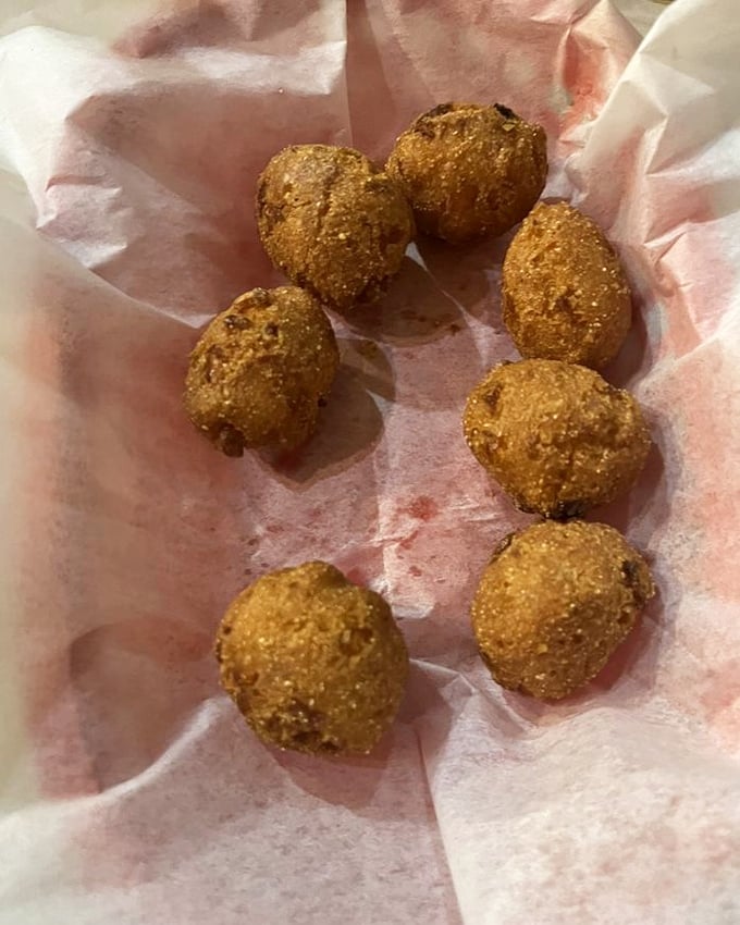 These aren't just hush puppies; they're golden orbs of cornmeal perfection. Crispy outside, tender inside—the supporting actors that steal every seafood scene.