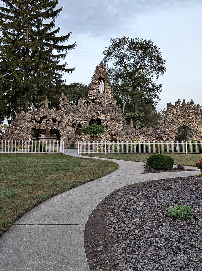 The Lourdes Grotto stands as a remarkable stone sanctuary, where craftsmanship and faith intertwine in an unexpected roadside marvel.