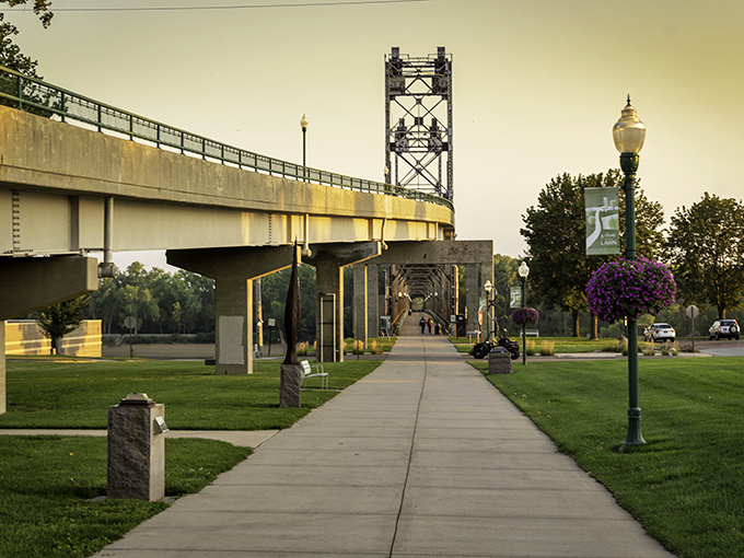 The Meridian Bridge walkway invites pedestrians to stroll above the Missouri, offering views that make even the most dedicated couch potatoes consider exercise worthwhile.