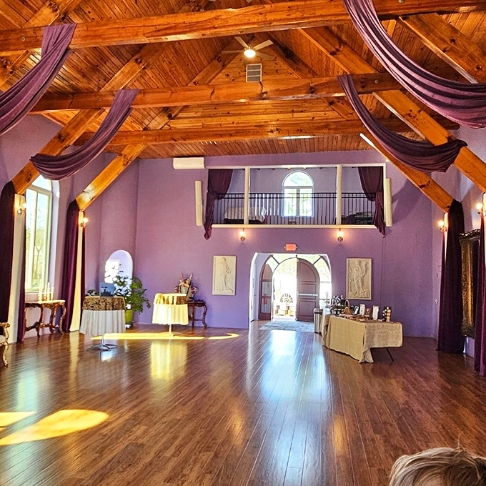 Soaring ceilings and rich purple walls turn this ballroom into the kind of space where Cinderella would feel right at home.