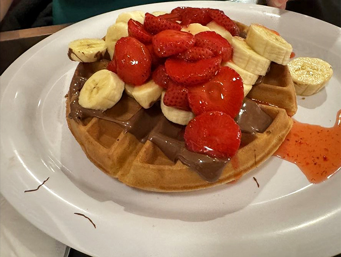 This Belgian waffle doesn't just have toppings&mdash;it has an entourage of strawberries, bananas, and Nutella that would make any breakfast celebrity jealous.