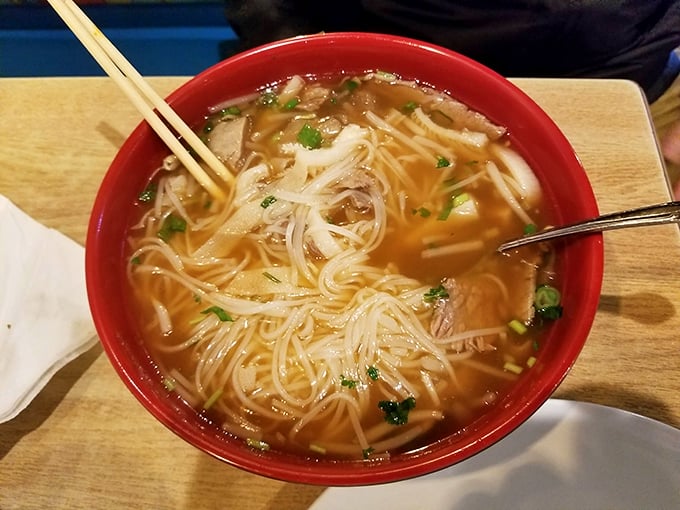 A steaming bowl of pho that could cure anything from a Wisconsin winter chill to existential dread, complete with fresh herbs and tender noodles.