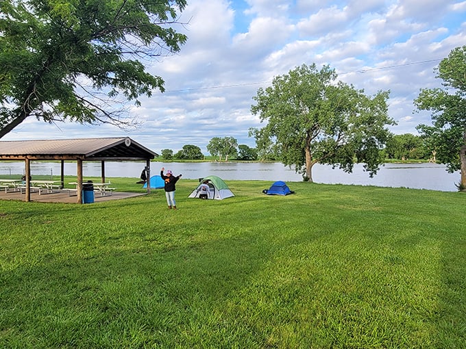 Camping doesn't get more idyllic than this waterfront spot where happy campers enjoy nature's soundtrack instead of Netflix notifications.
