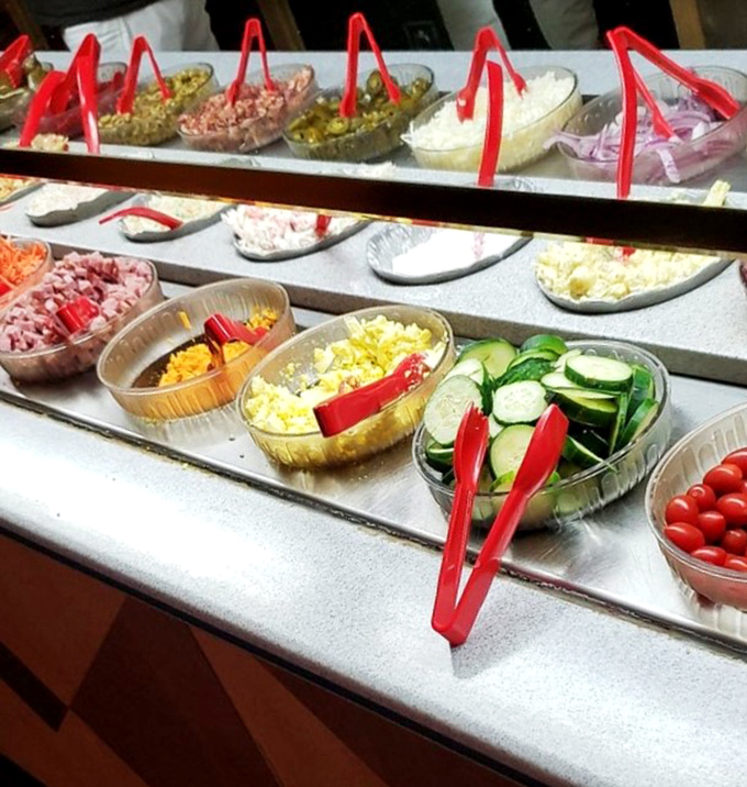 The salad bar features fresh vegetables arranged with military precision—nature's apology for how much meat you're about to consume.