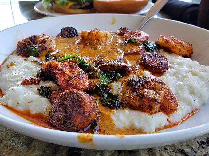 Shrimp and grits elevated to an art form. Blackened shrimp and andouille sausage swim in Cajun cream sauce atop creamy gouda grits—Southern comfort in a bowl.