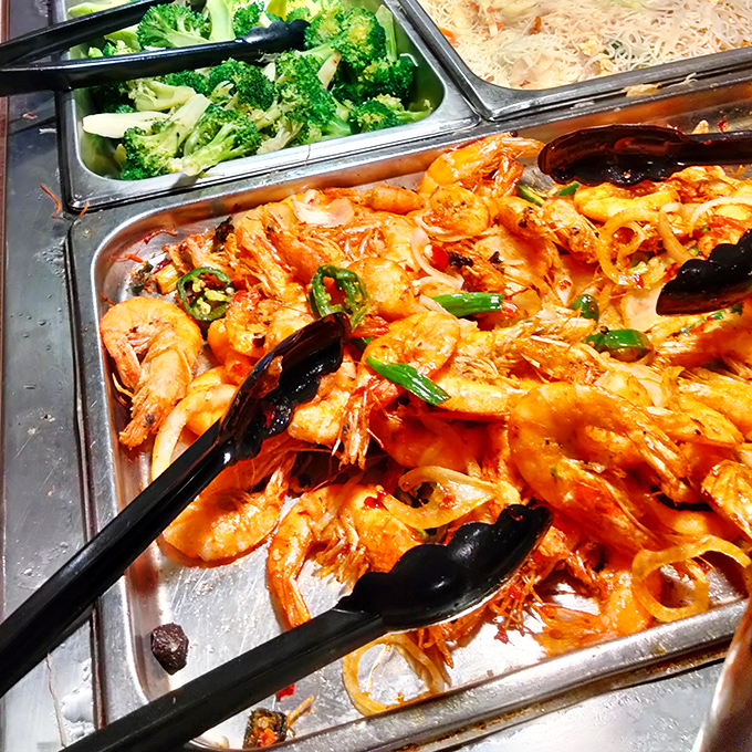These plump shrimp, bathed in spicy sauce and nestled beside fresh broccoli, are the unsung heroes of the seafood station.