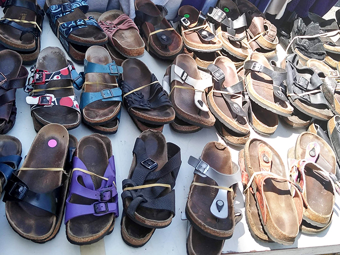 Well-loved Birkenstocks and sandals lined up like retired travelers with stories etched into their worn soles.