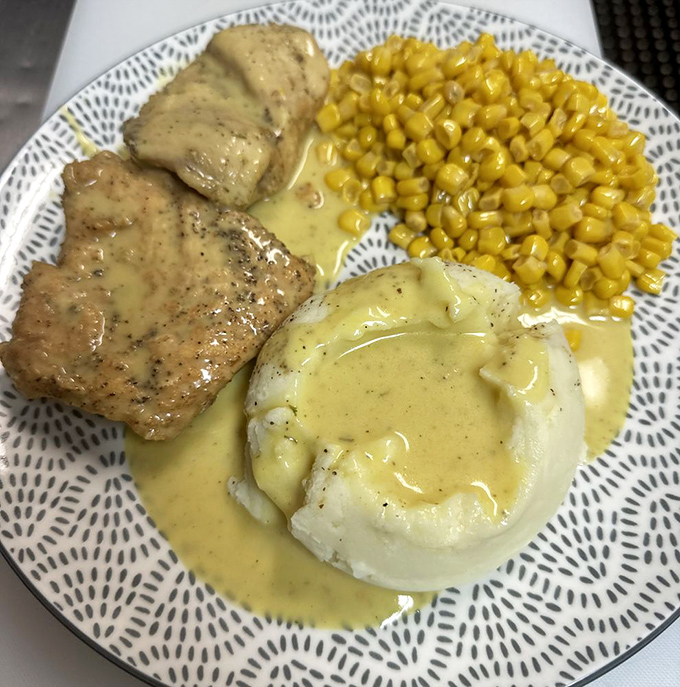 Comfort on a plate: tender chicken smothered in gravy alongside mashed potatoes that clearly never came from a box.
