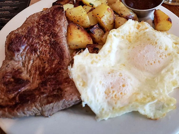 This isn't just steak and eggs; it's a morning masterpiece where perfectly seared beef meets sunny-side-up eggs with crispy-edged whites and golden centers.
