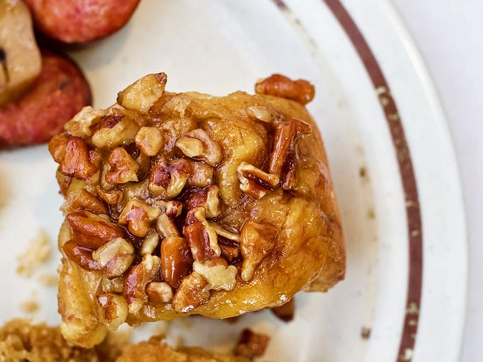 This sticky bun isn't just breakfast &ndash; it's an edible love letter from Pennsylvania Dutch country, complete with pecans standing guard over caramelized perfection.