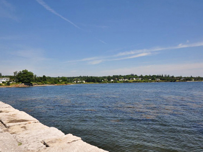 The stone seawall stands like a patient grandfather, watching over Penobscot Bay's ever-changing moods for centuries.