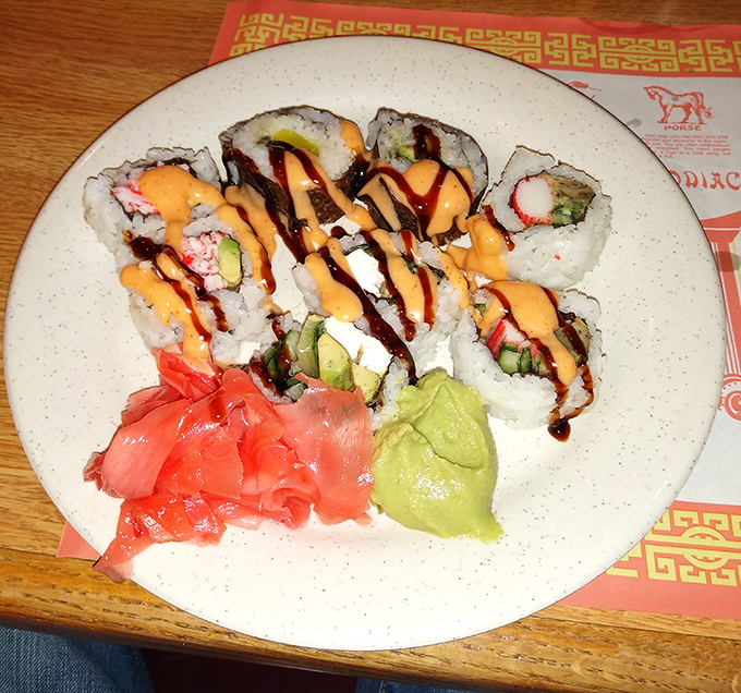 Colorful sushi rolls drizzled with spicy mayo prove that buffet dining doesn't mean sacrificing freshness or presentation. A delightful surprise!