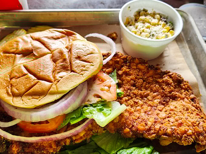 This isn't just a sandwich; it's Iowa's crispy tenderloin masterpiece with a side of comfort. The cornbread alone deserves its own fan club.