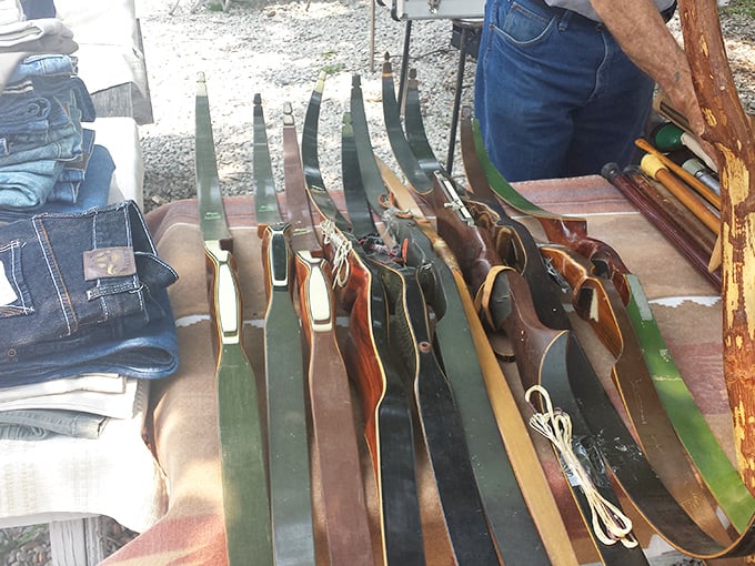 Not your average sporting goods display! These vintage bows tell stories of hunts past, waiting for their next adventure with a new owner.