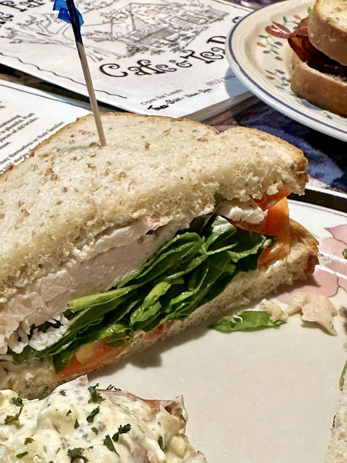 This isn't just a sandwich; it's architecture. Layers of turkey, fresh greens, and creamy spread create the skyscraper of lunch options.